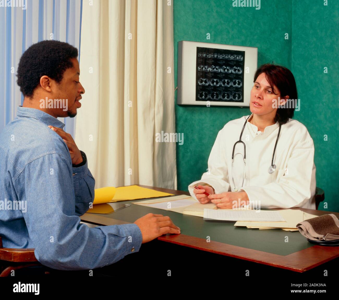 Consultation for shoulder pain. Man describes his symptoms of shoulder ...