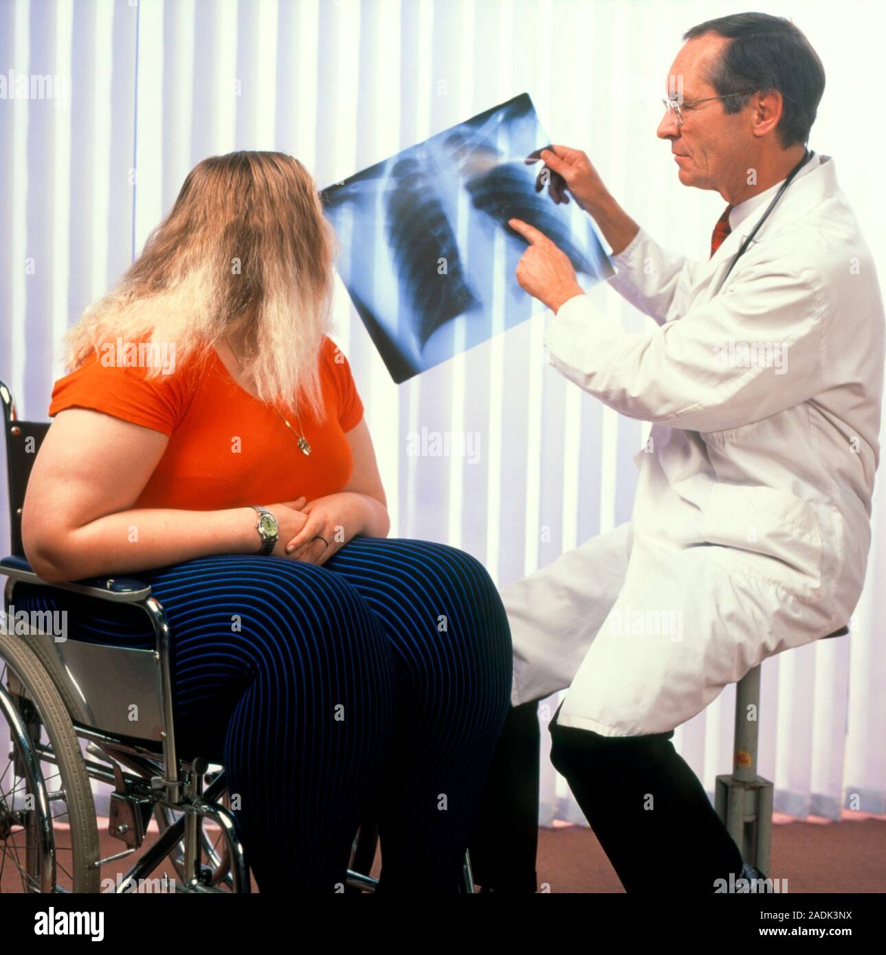 Medical consultation. General practice (GP) doctor explains a chest X ...