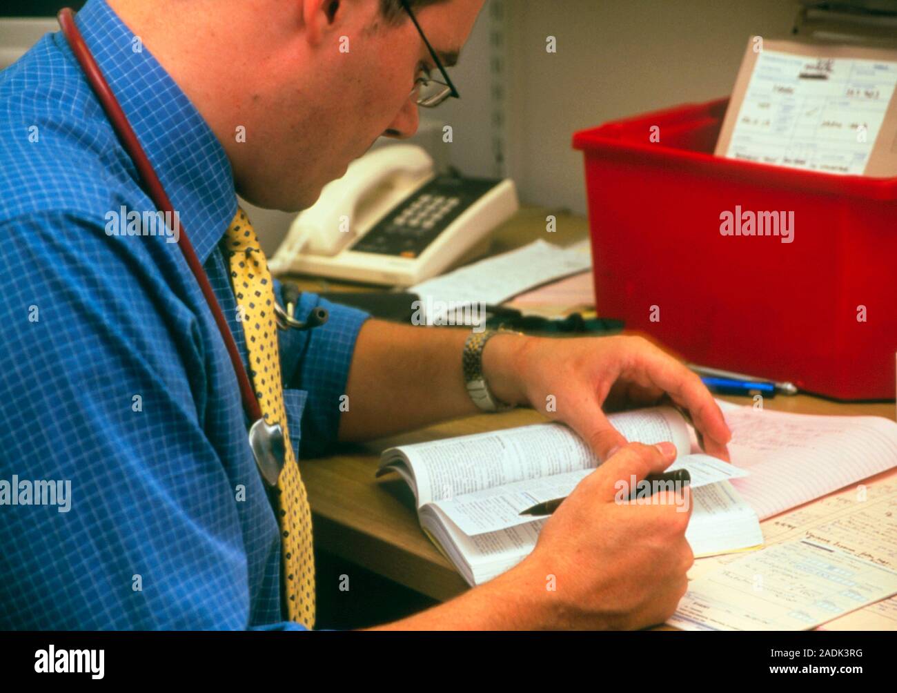 General practice doctor. General practice doctor studying a medical ...
