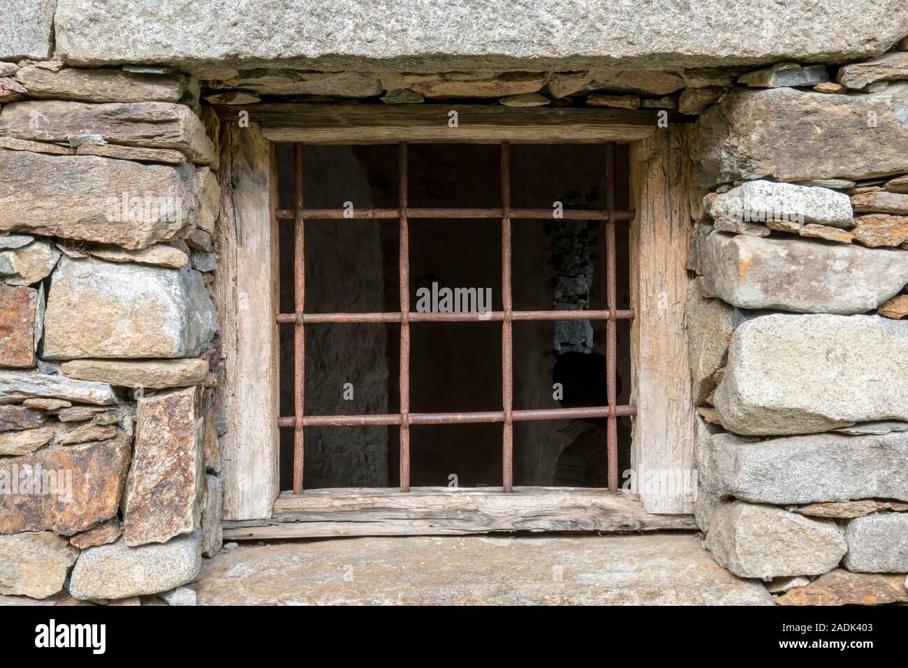Window with bars in stone wall Stock Photo - Alamy
