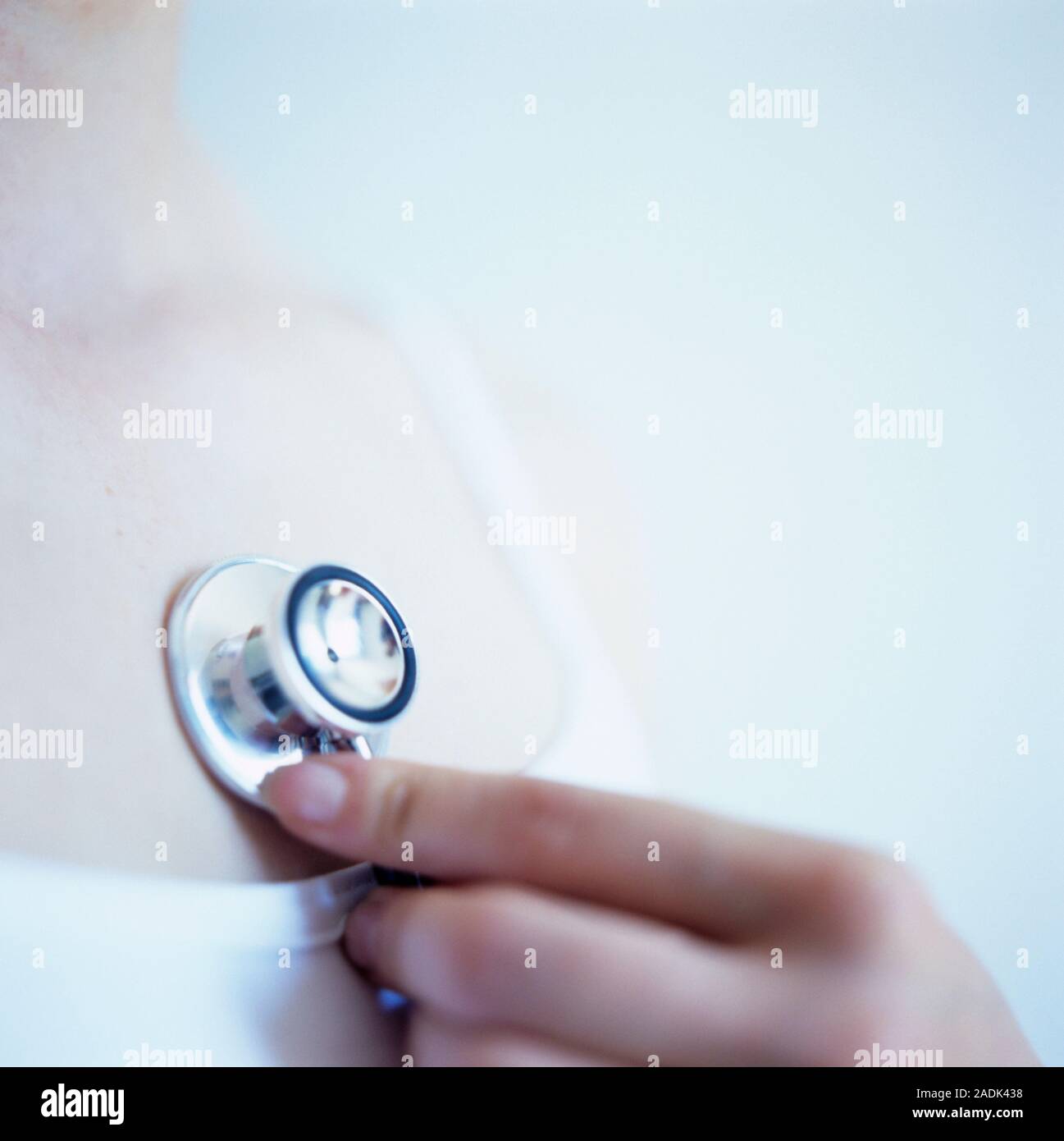 Stethoscope being used to listen to a woman's chest. This device is ...