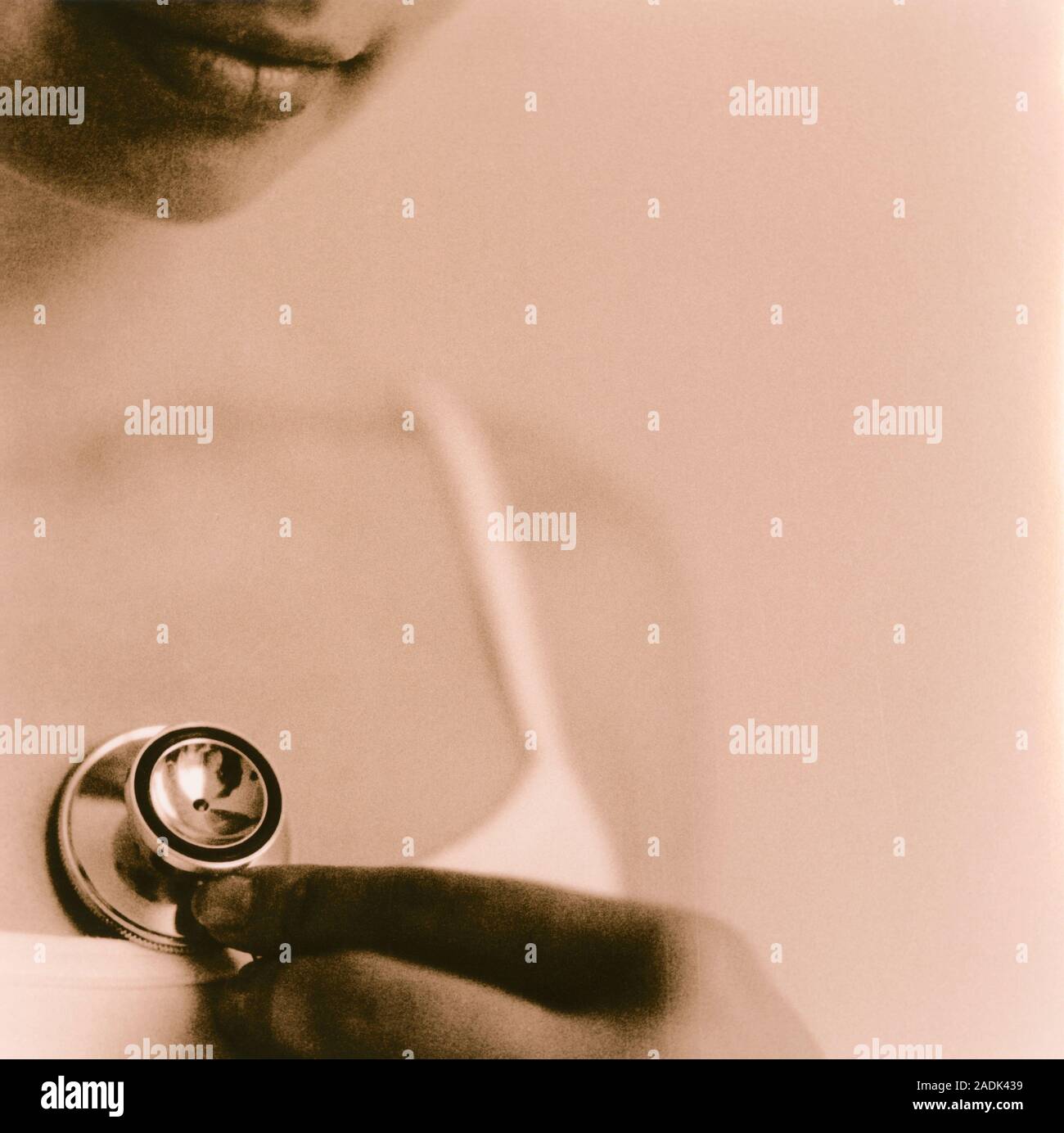 Stethoscope examination of a woman's chest. A stethoscope is commonly ...