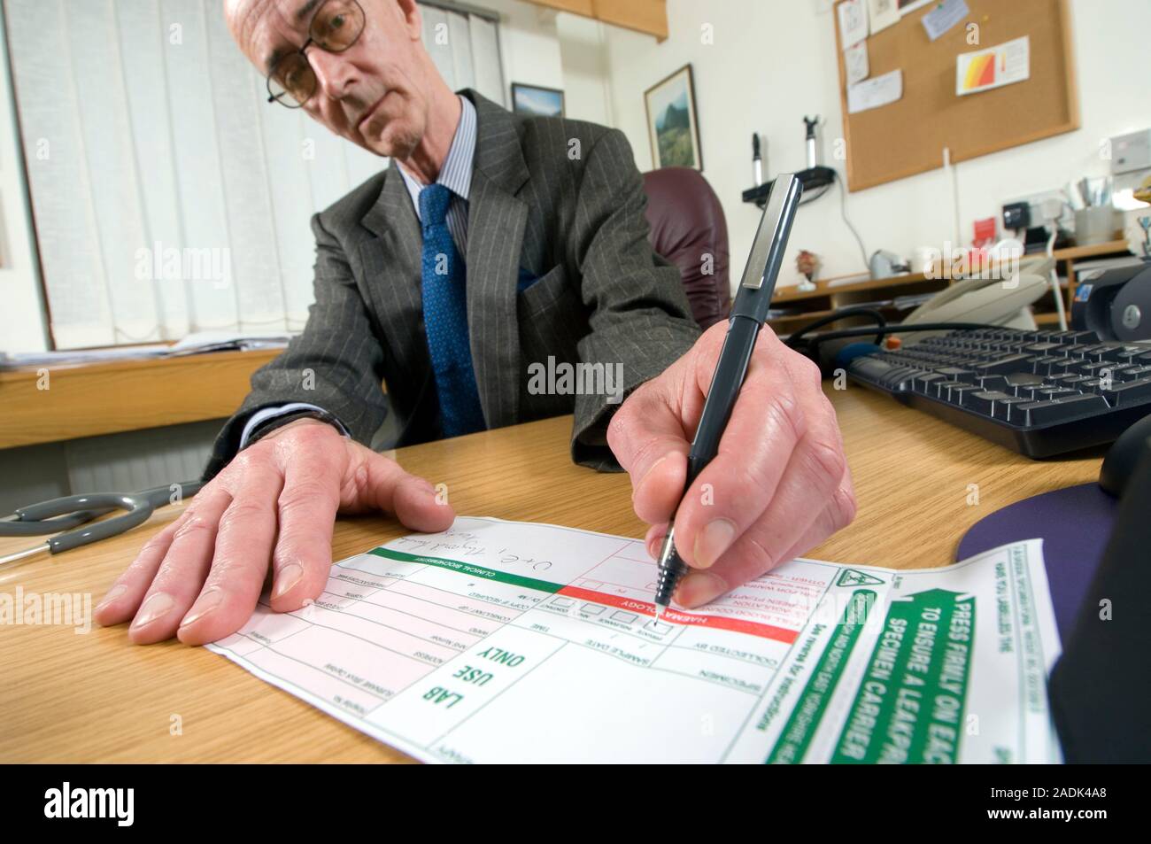 MODEL RELEASED. Specimen envelope being filled out by a doctor. This is ...