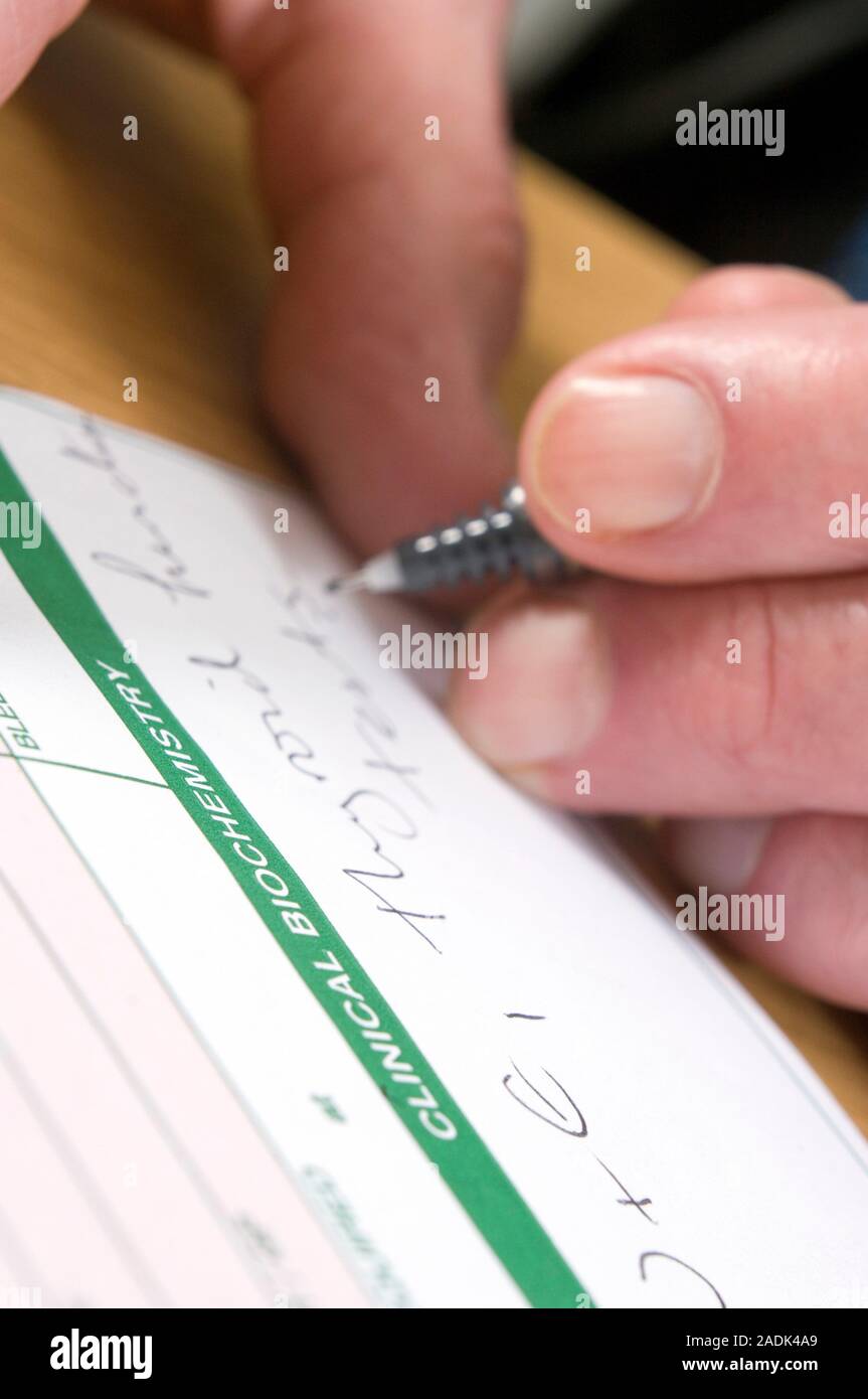 MODEL RELEASED. Specimen envelope being filled out by a doctor. This is ...