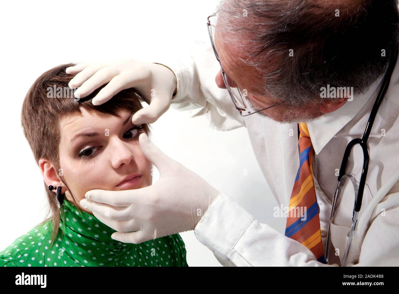 MODEL RELEASED. Eye examination. Doctor carrying out an examination of ...