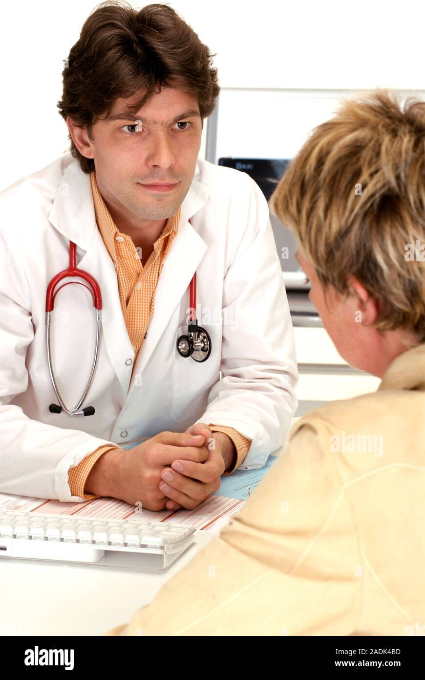 MODEL RELEASED. Medical consultation. General practitioner listening to ...