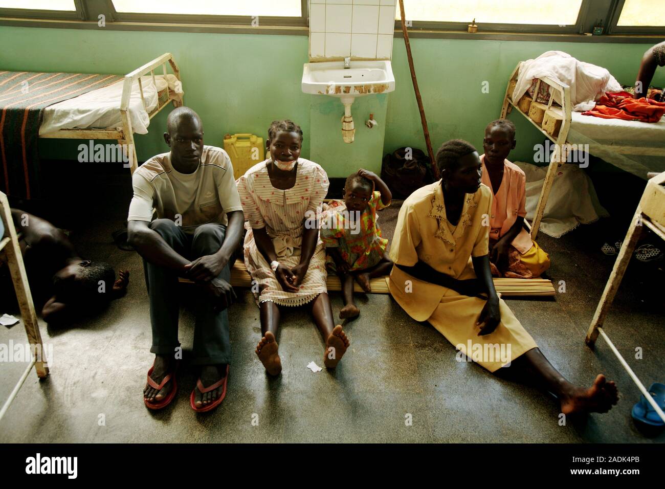 Hospital ward. Patients sitting on the floor of an overcrowded hospital ...