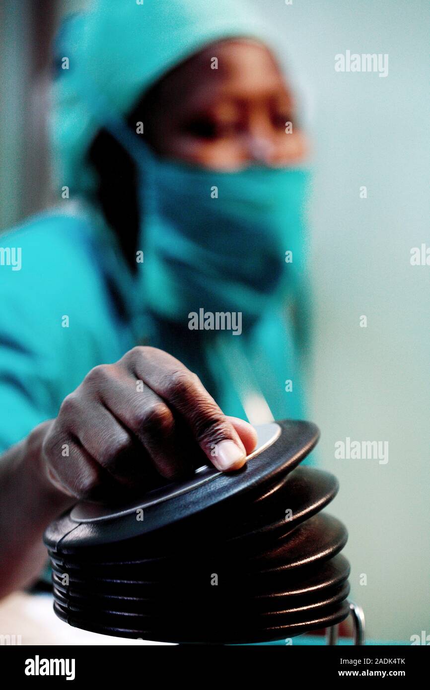 MODEL RELEASED. Using a manual respirator. Surgeon pumping a ventilator ...