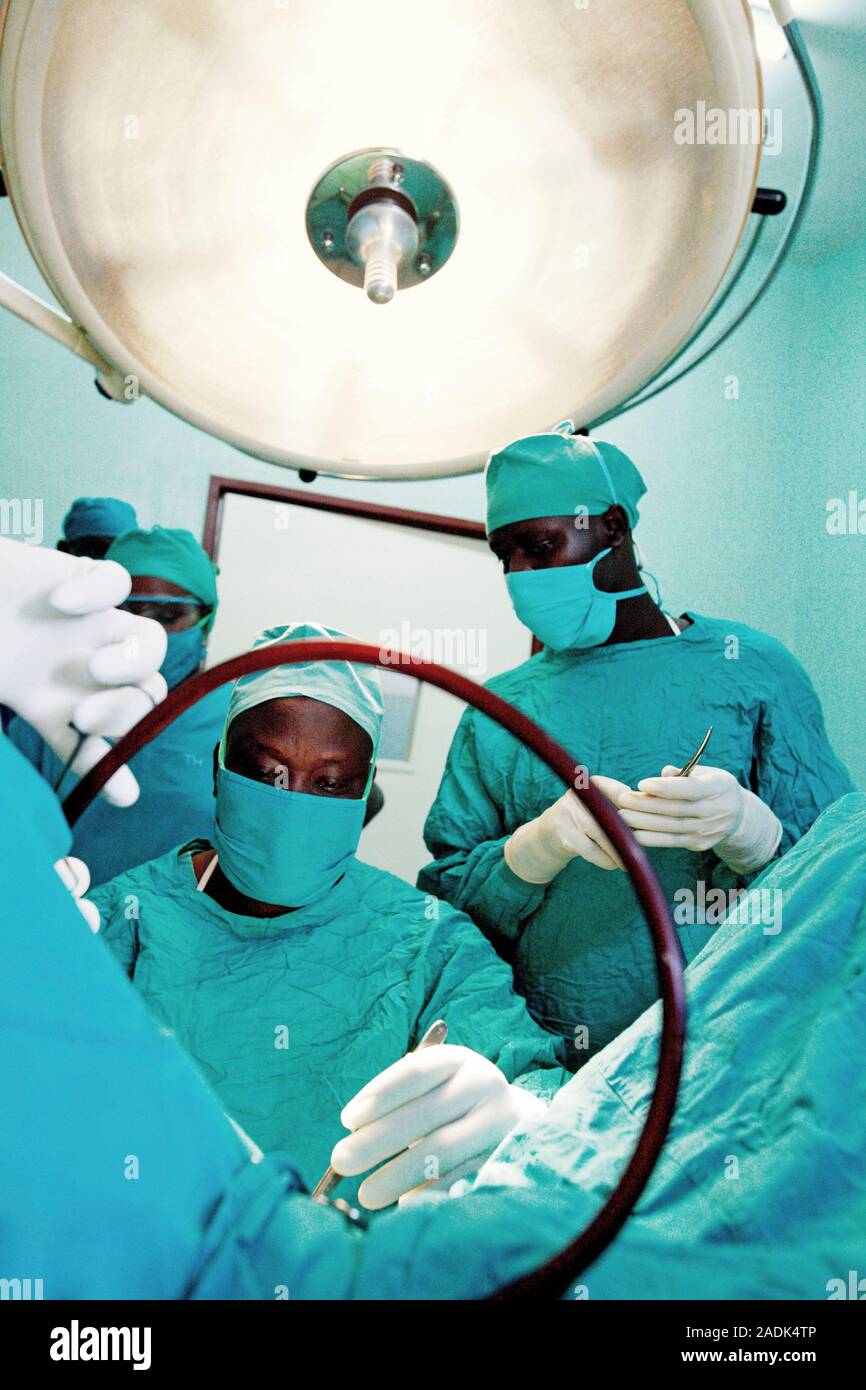 MODEL RELEASED. Hysterectomy surgery. Surgeons conducting an operation ...