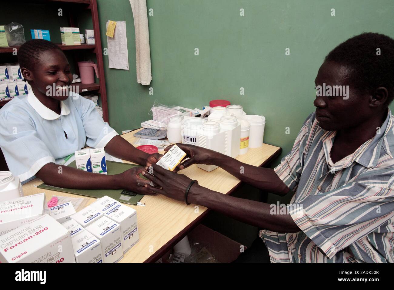 MODEL RELEASED. Dispensing medication. Pharmacist giving boxes of ...