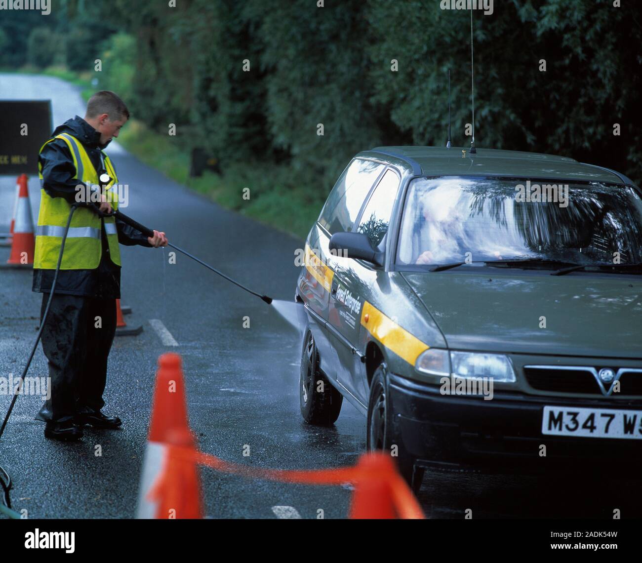 Foot-and-mouth disease (FMD) containment. Car being sprayed with ...
