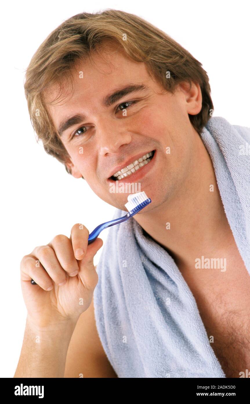 MODEL RELEASED. Oral hygiene. Man about to brush his teeth Stock Photo ...