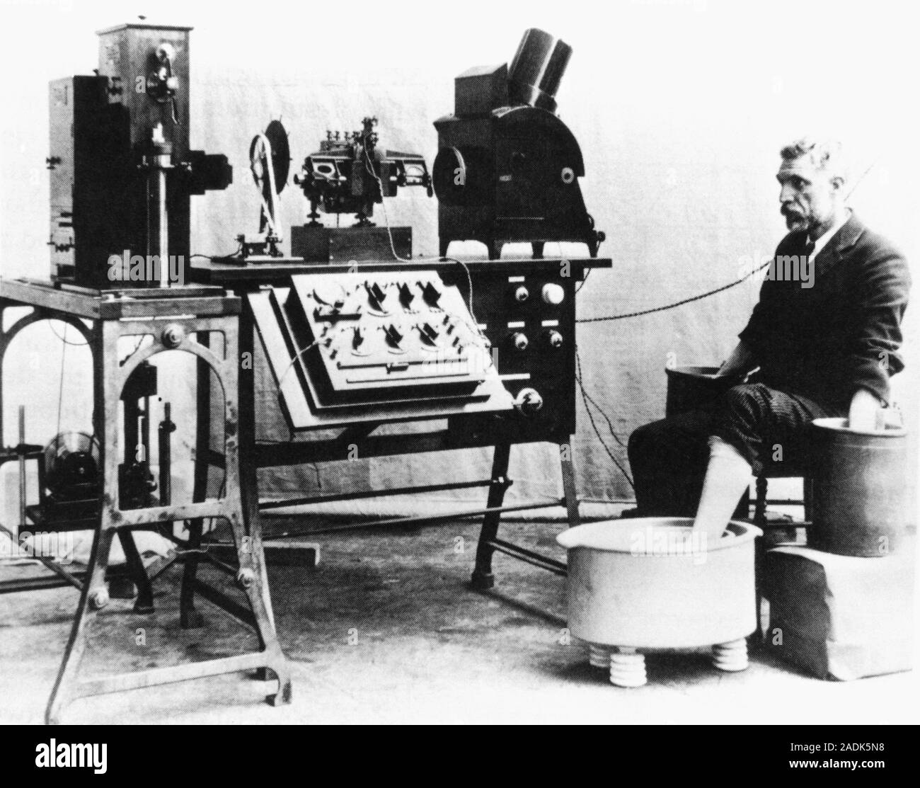 Heart measurement. Patient using an early electrocardiograph (ECG) to ...