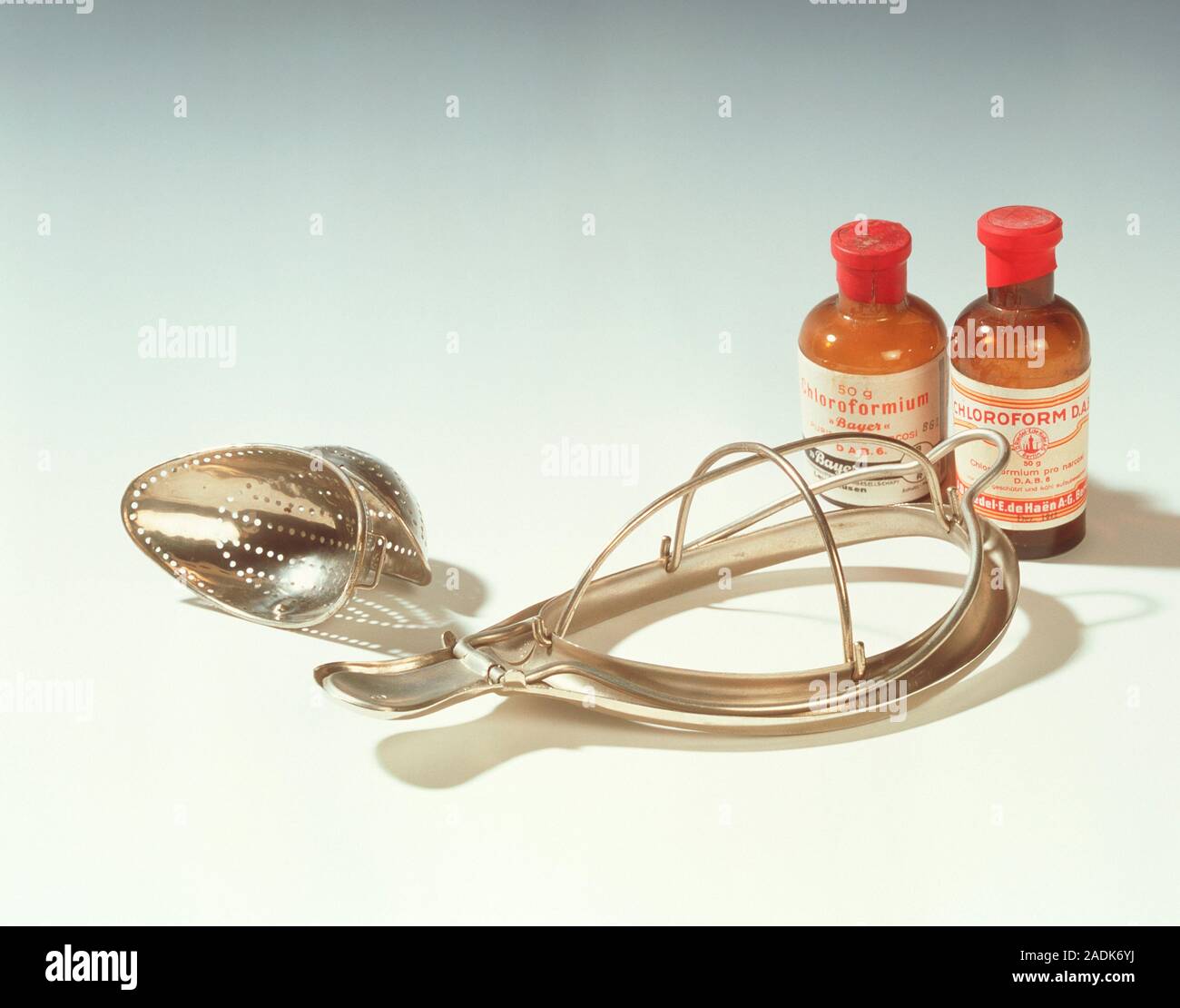 Historical anaesthesia face mask and bottles of chloroform ...