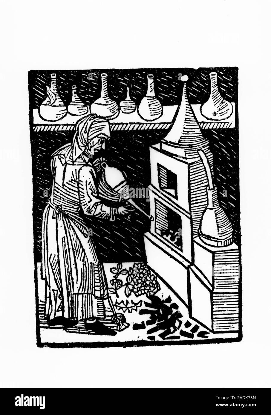 Medicinal distillation. Medieval apothecary using bellows on the ...