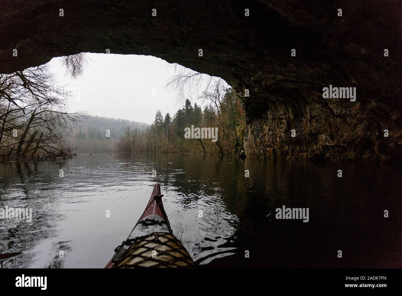 red kayak kayaking in the flooded forest at Rakov skocjan, Slovenia ...