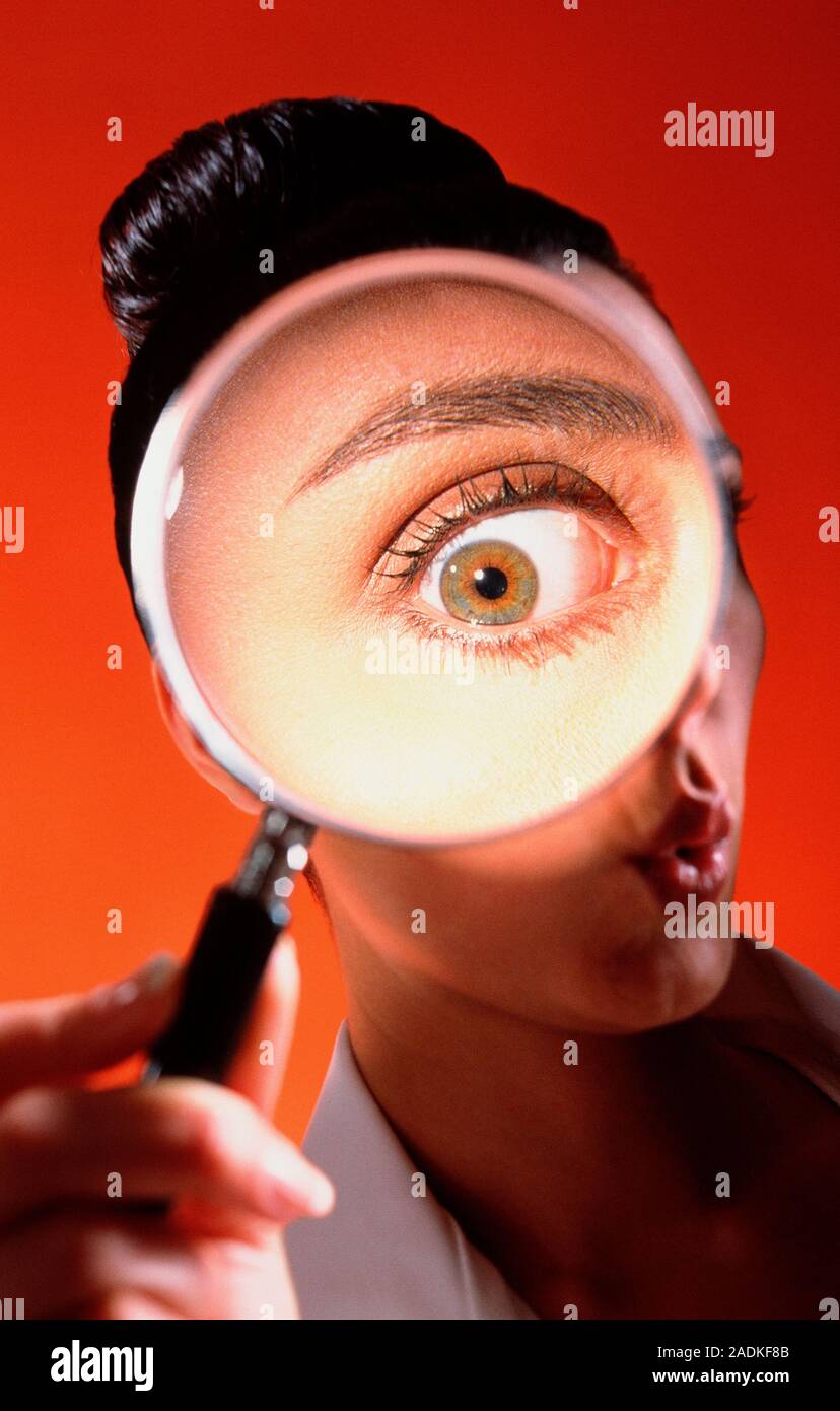 Eye. Woman's eye seen through a magnifying glass. This image could ...