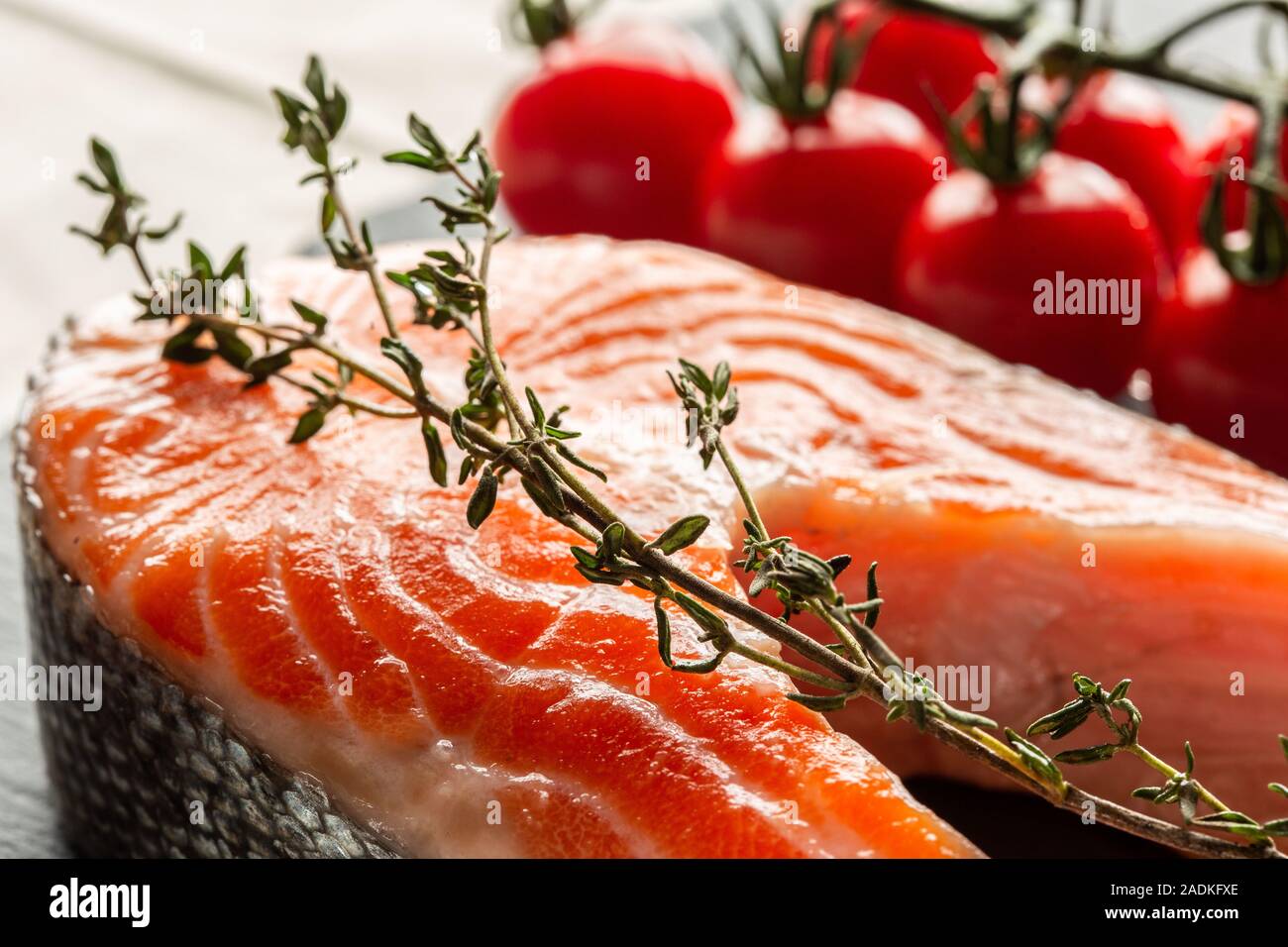 Branch of thyme placed on the slice of raw red fish Stock Photo - Alamy