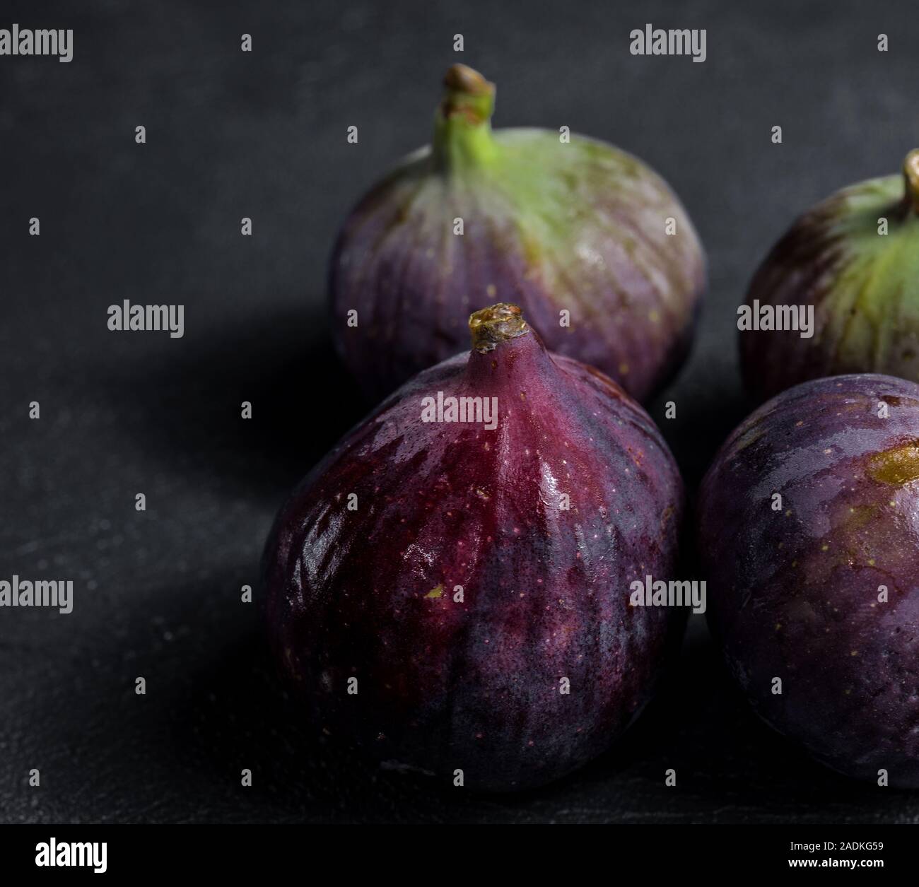 fresh figs close-up on black background. dark moody photo Stock Photo ...