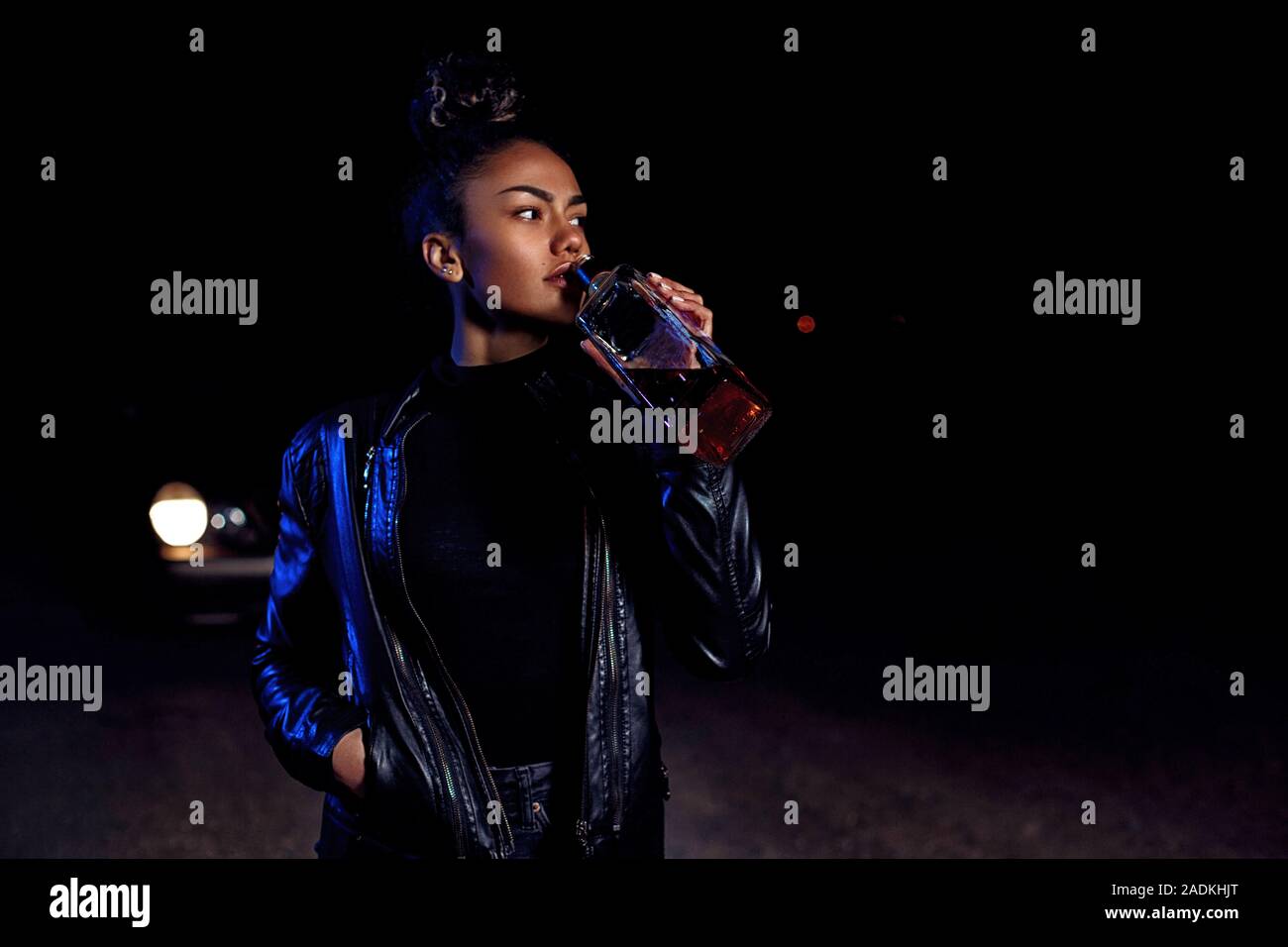 drunk young African American mulatto girl in a leather jacket and black ...