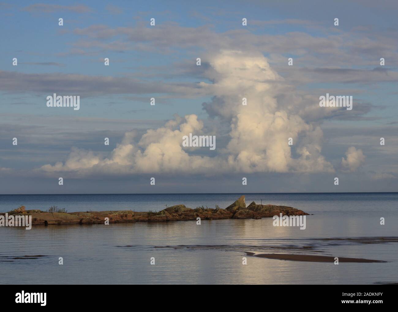 Rock formation and cumulus cloud over Lake Vanern Stock Photo - Alamy