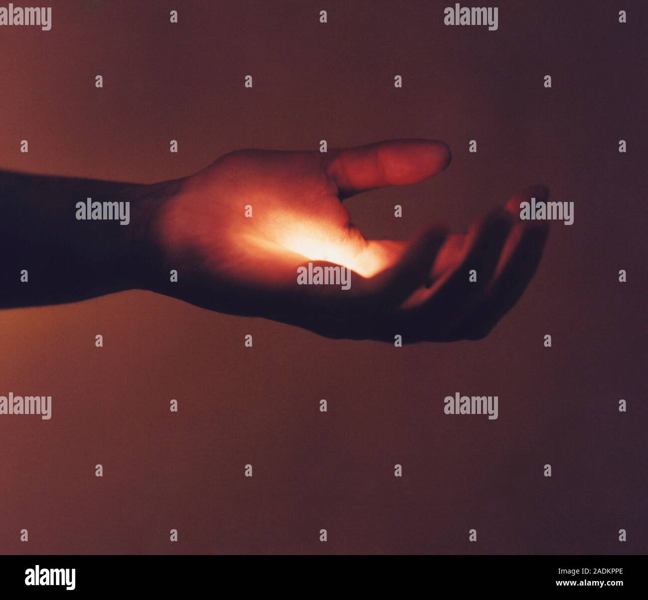 Hand with a light shining on it Stock Photo - Alamy