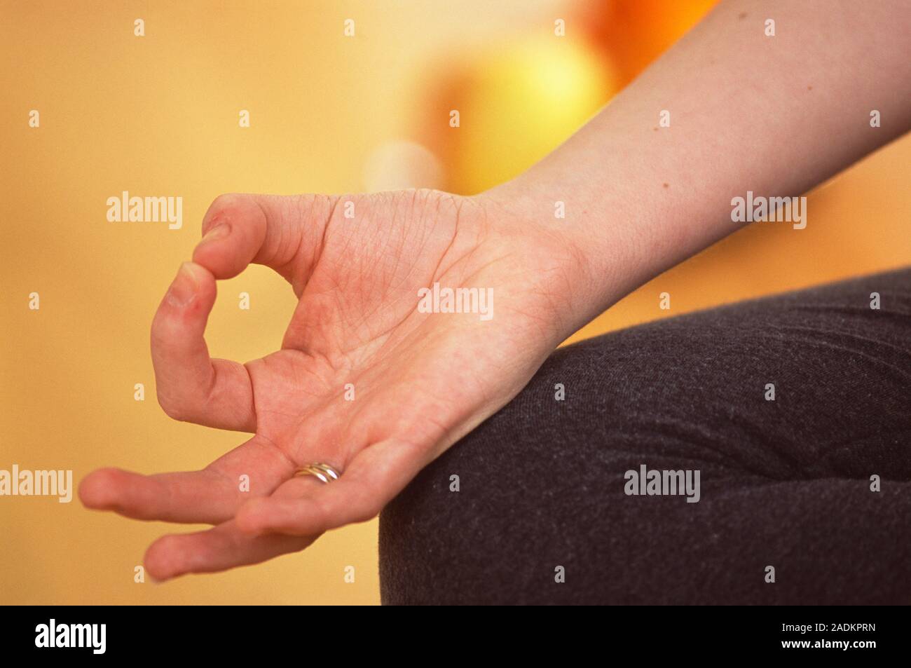 Hand with thumb and forefinger shaped to form an 'O' resting on a ...