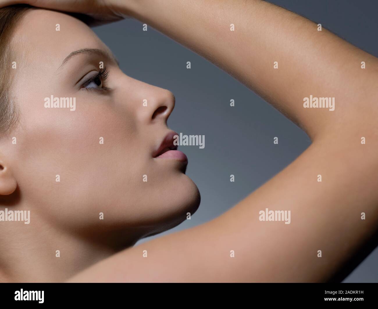 MODEL RELEASED. Woman's face and arm Stock Photo - Alamy