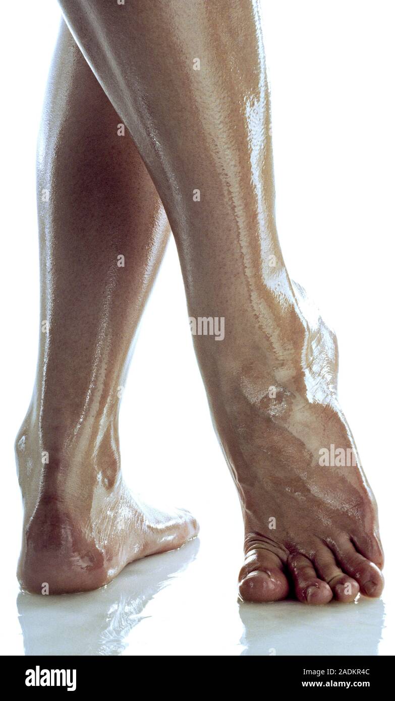 MODEL RELEASED. Crossed legs with pointed toes Stock Photo - Alamy