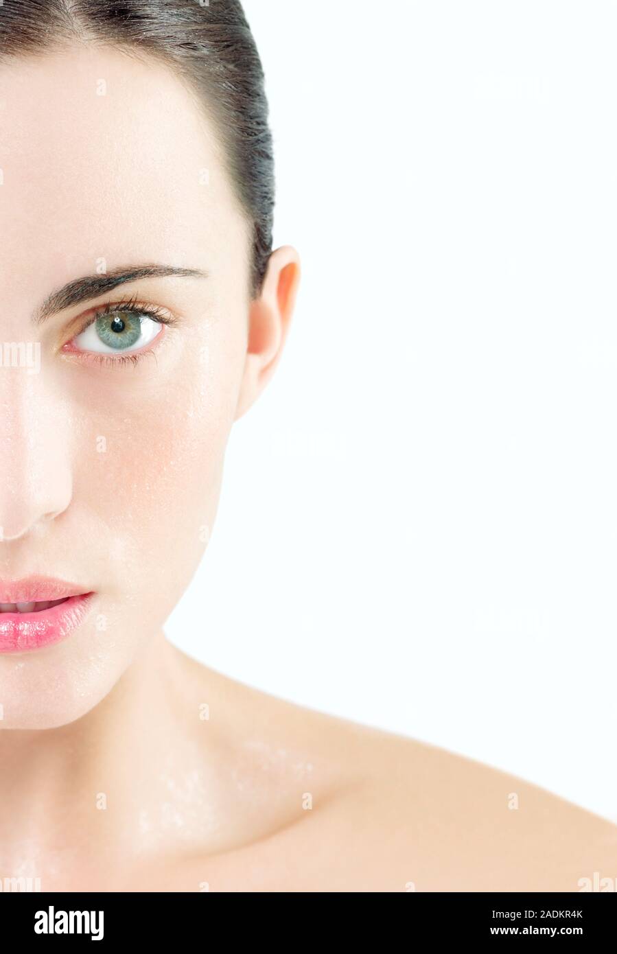 MODEL RELEASED. Woman's face with droplets of water on the skin. She is ...