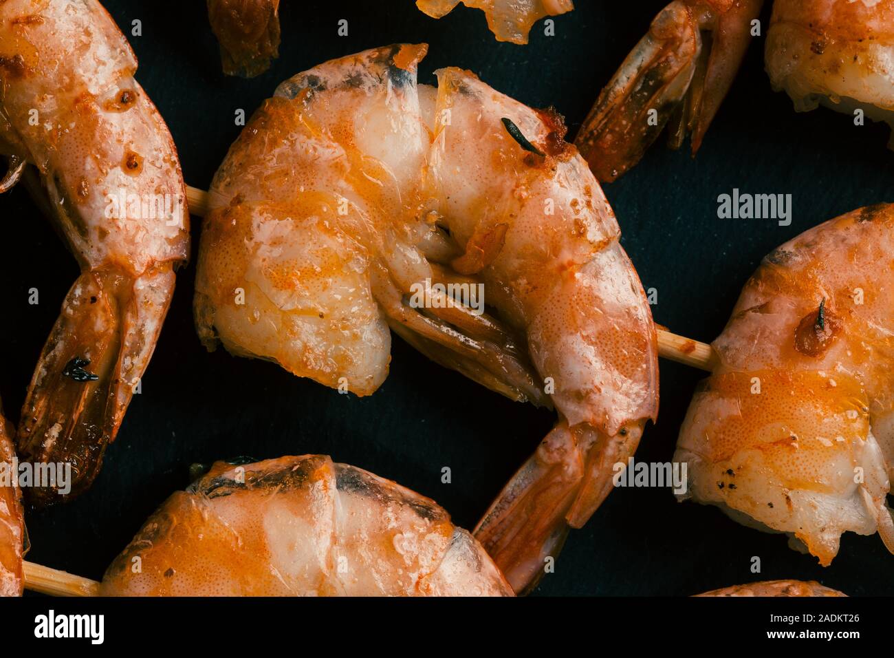 Close up of fried crispy headless prawns on wooden sticks Stock Photo ...