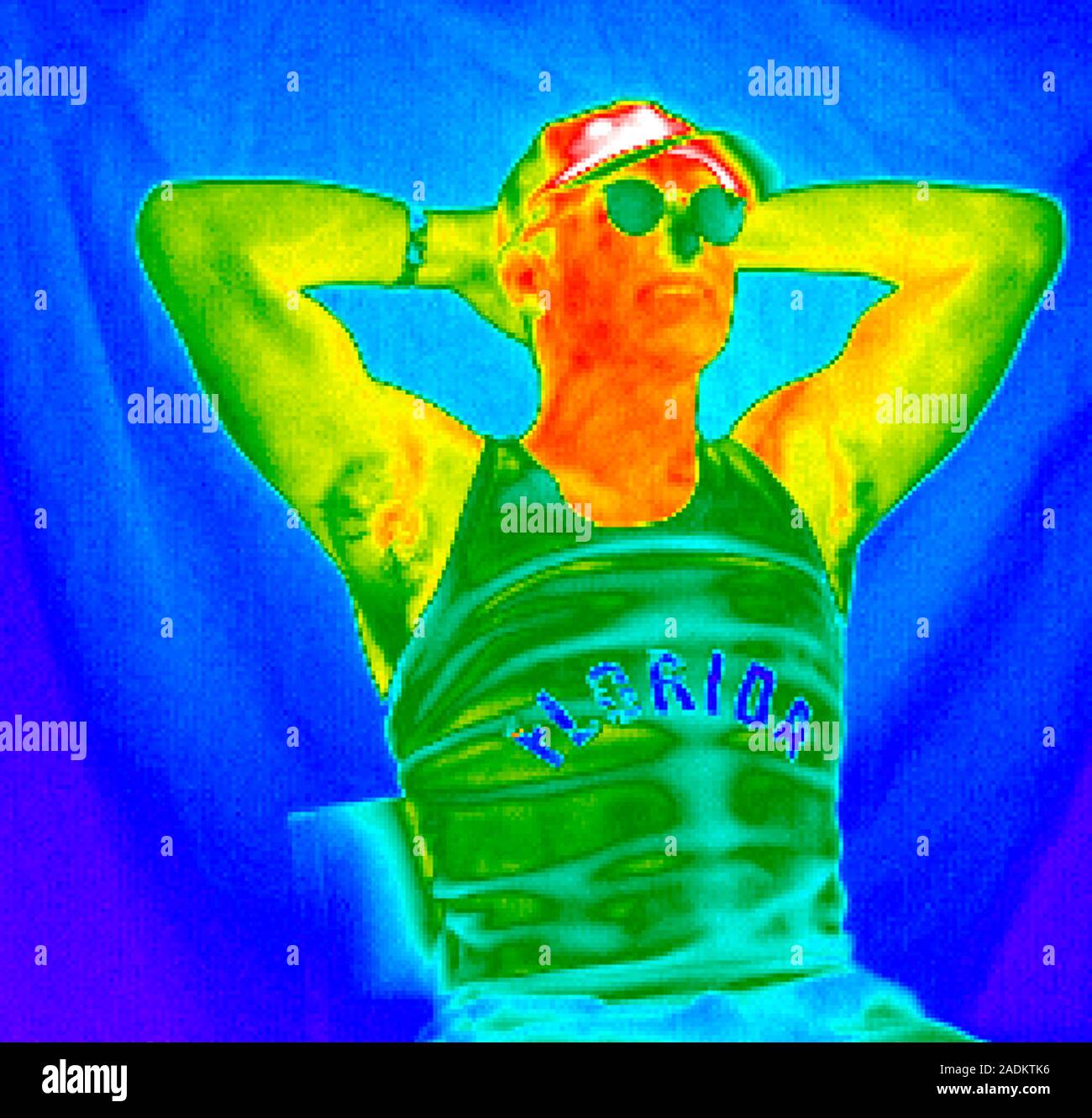 Thermogram of a man sunbathing. Thermograms show the emission of ...