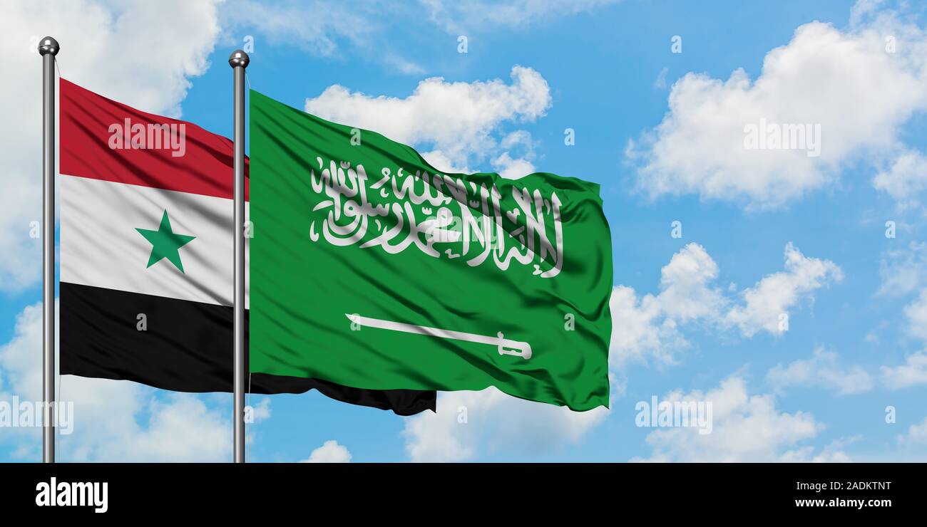 Syria and Saudi Arabia flag waving in the wind against white cloudy ...