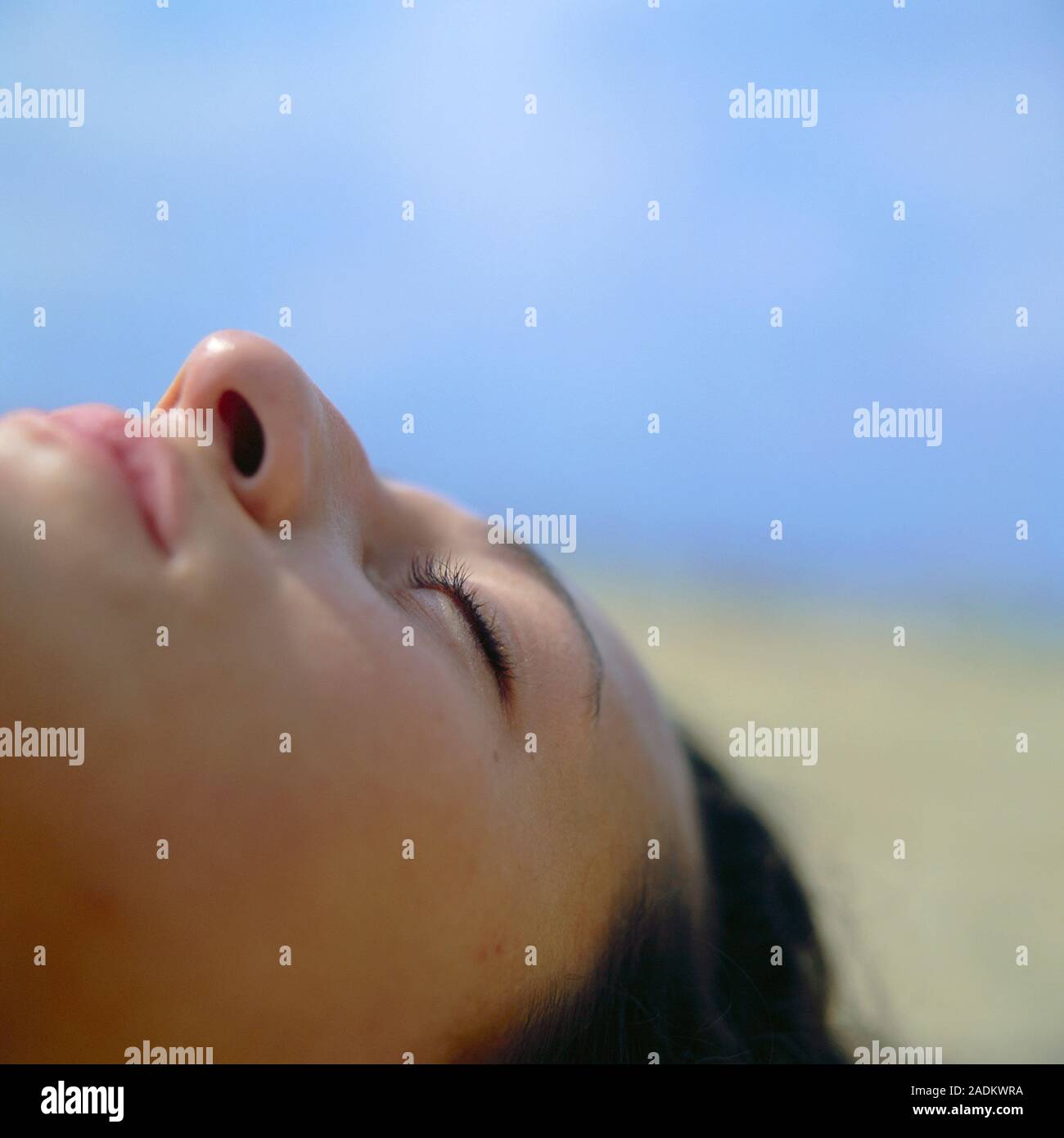 Face of a woman sleeping on a sandy beach Stock Photo - Alamy