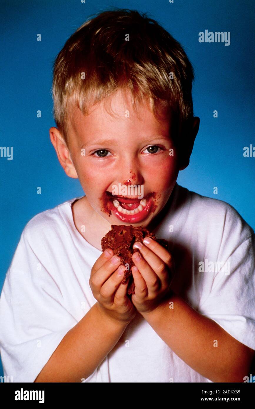 Boy eating. Young boy eating a chocolate cake. Sweet food such as this ...