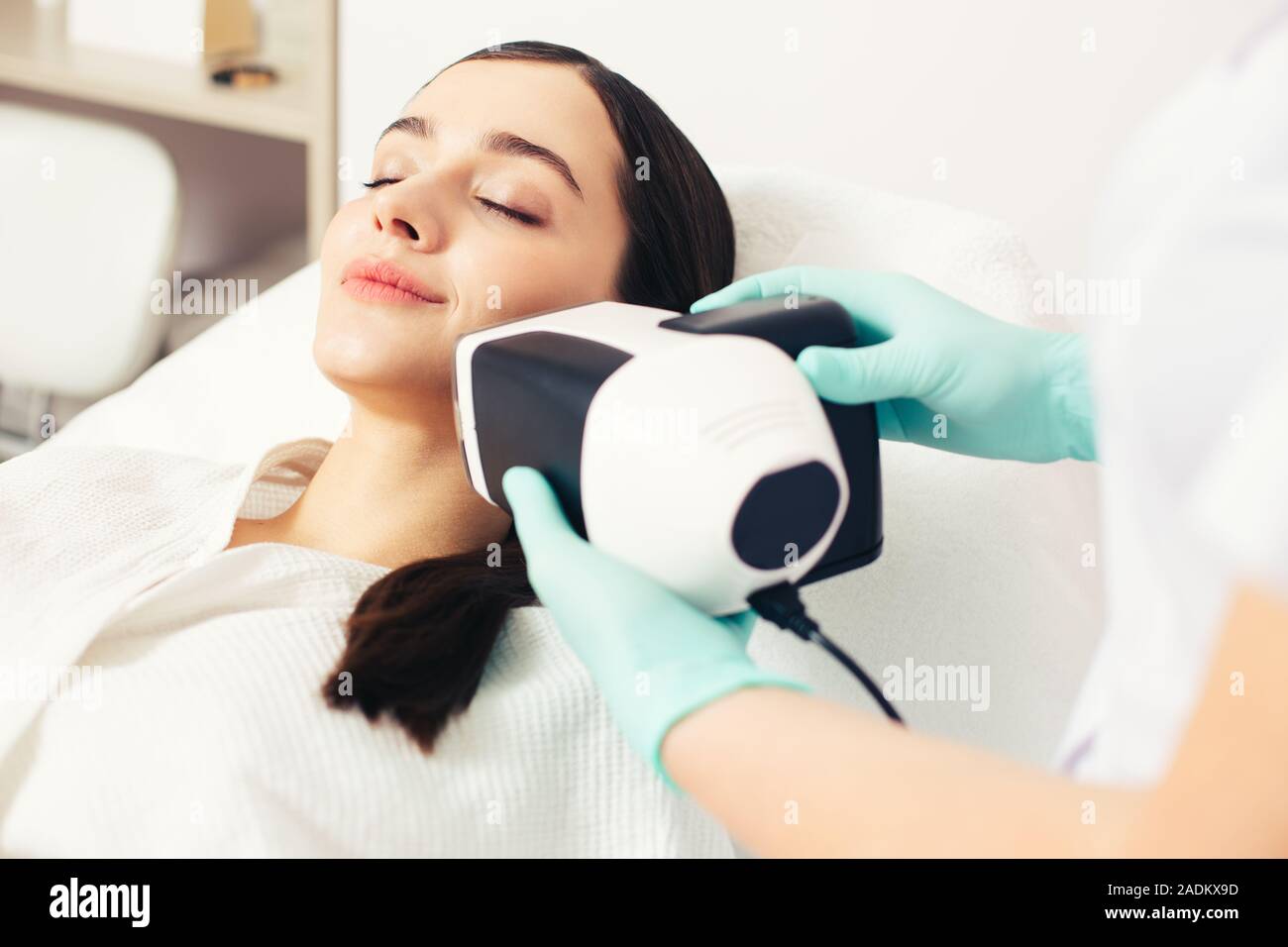 Face of peaceful woman with skin analysis camera near the cheek Stock ...