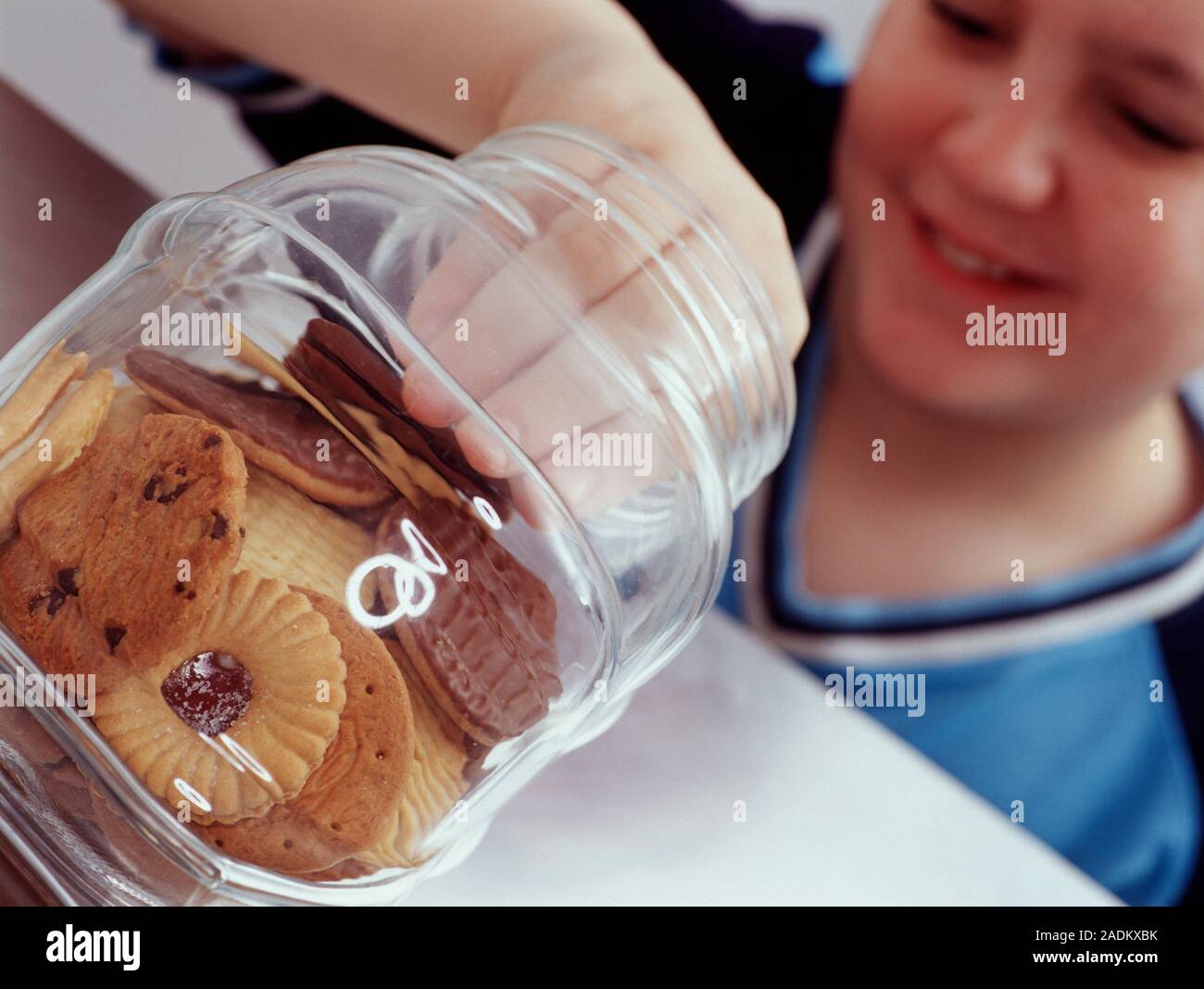 Eating biscuits. Boy reaching into a jar full of biscuits. These ...