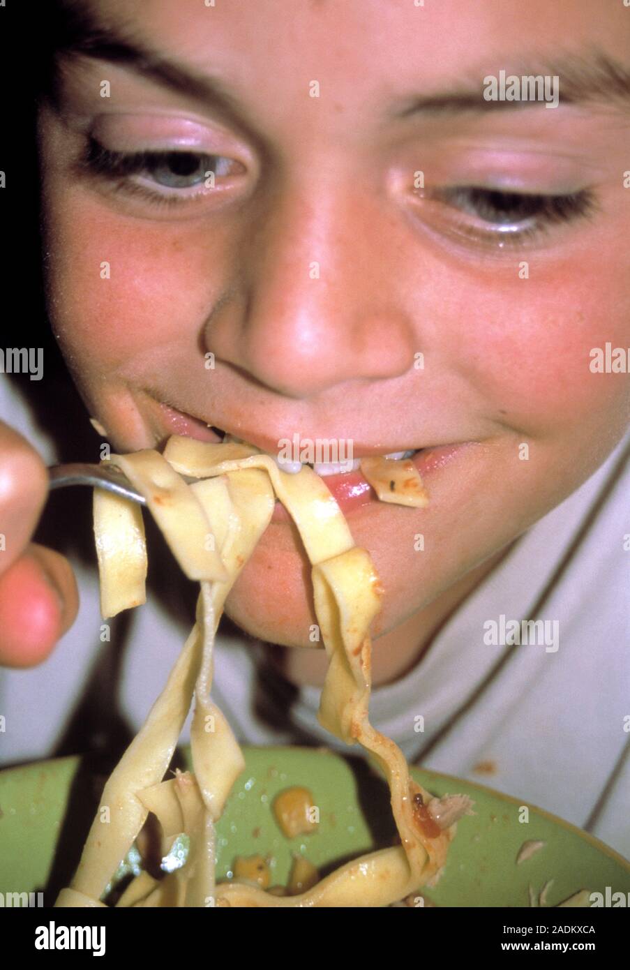 Hungry boy eating pasta Stock Photo - Alamy