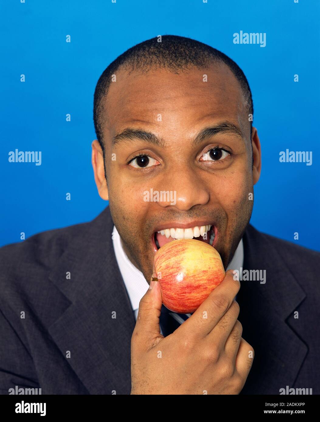 MODEL RELEASED. Man eating an apple Stock Photo - Alamy