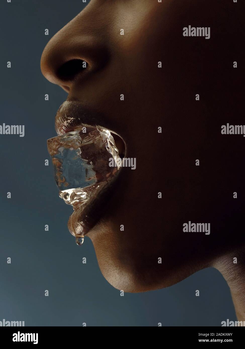 MODEL RELEASED. Melting ice cube in a woman's mouth Stock Photo - Alamy