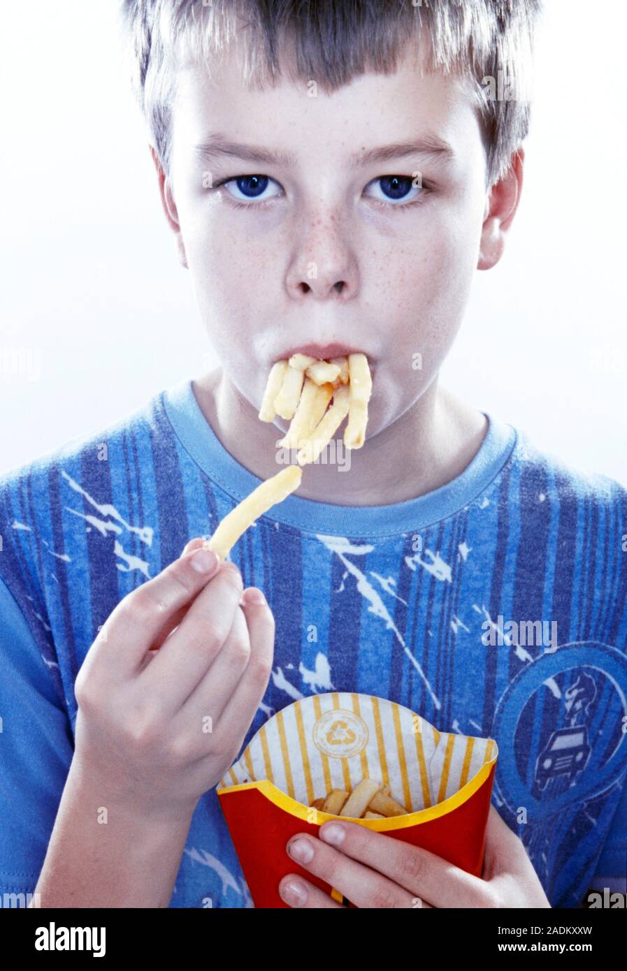 MODEL RELEASED. Boy eating french fries Stock Photo - Alamy