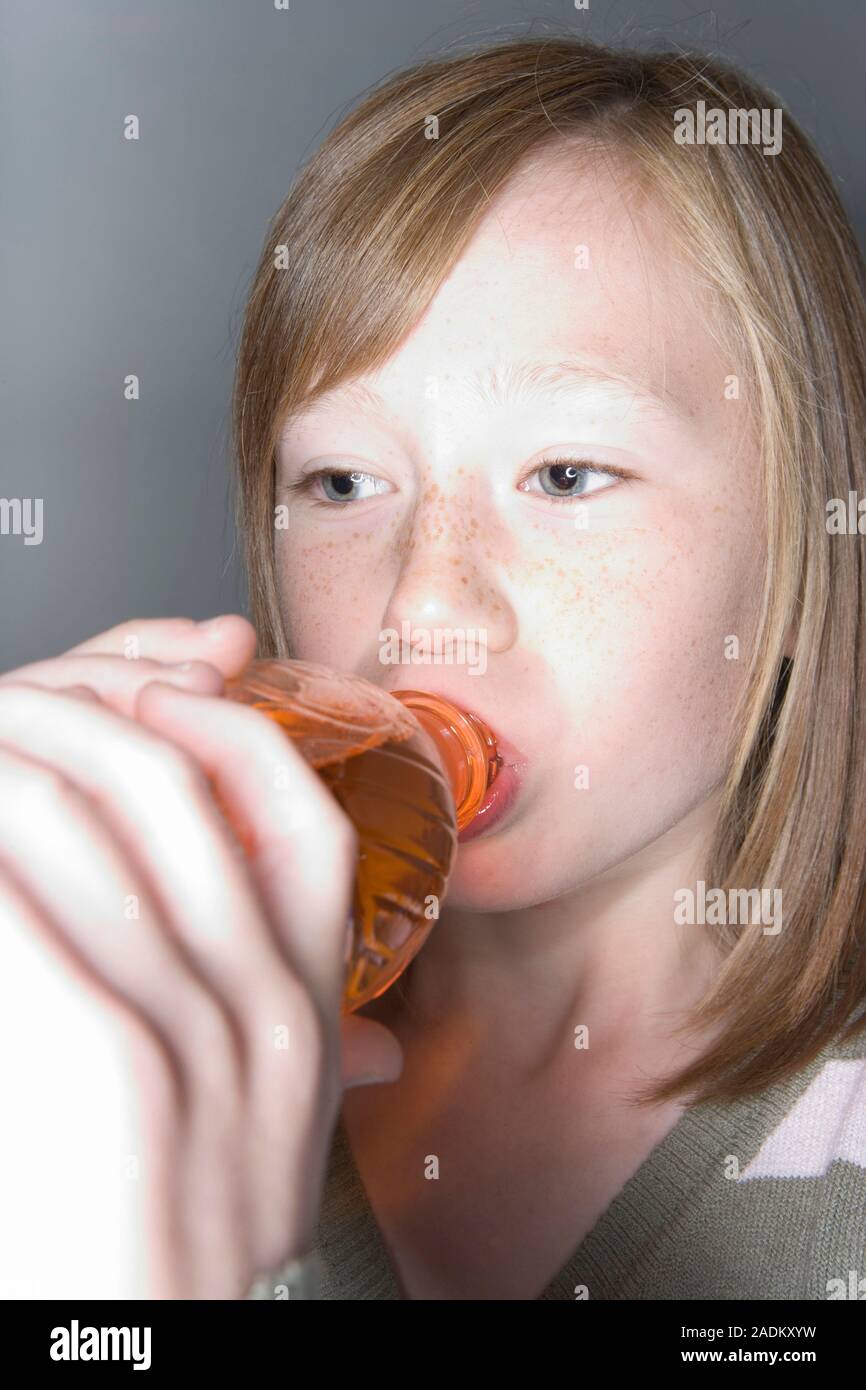 MODEL RELEASED. Girl drinking a fizzy drink from a bottle Stock Photo ...
