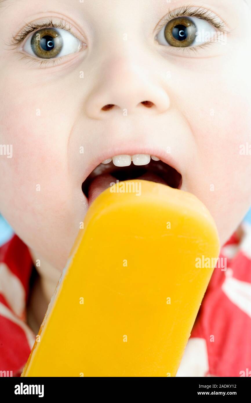 Toddler licking an ice lolly Stock Photo - Alamy