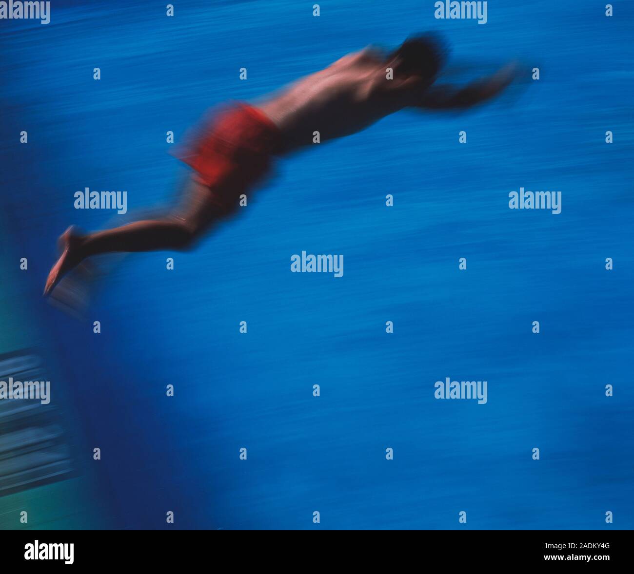 Diving. Time-exposure image of a man diving into a swimming pool Stock ...