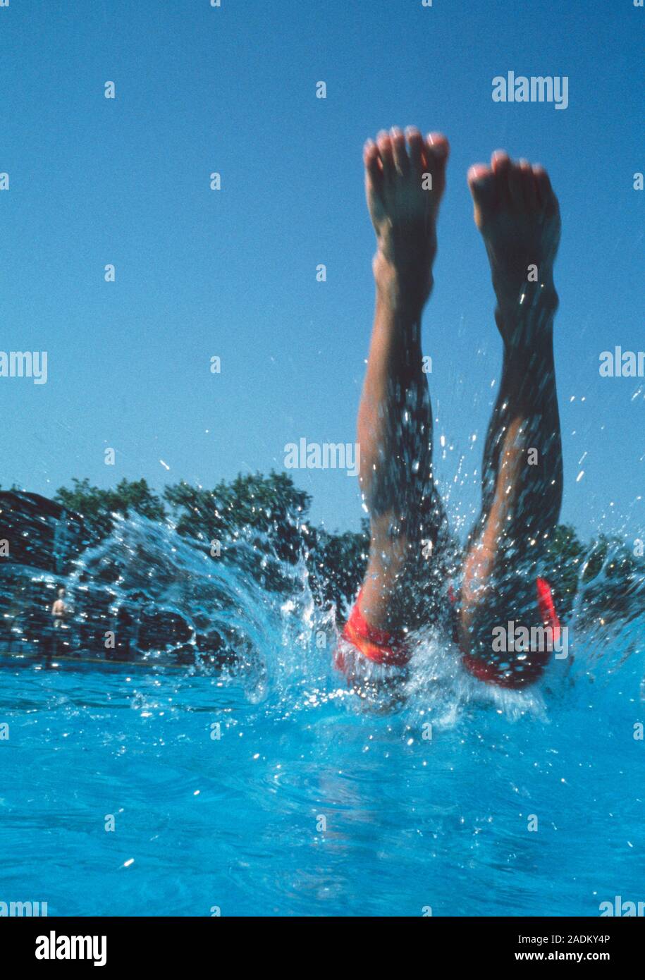 Diving. Splash of water as a man dives into a swimming pool Stock Photo ...