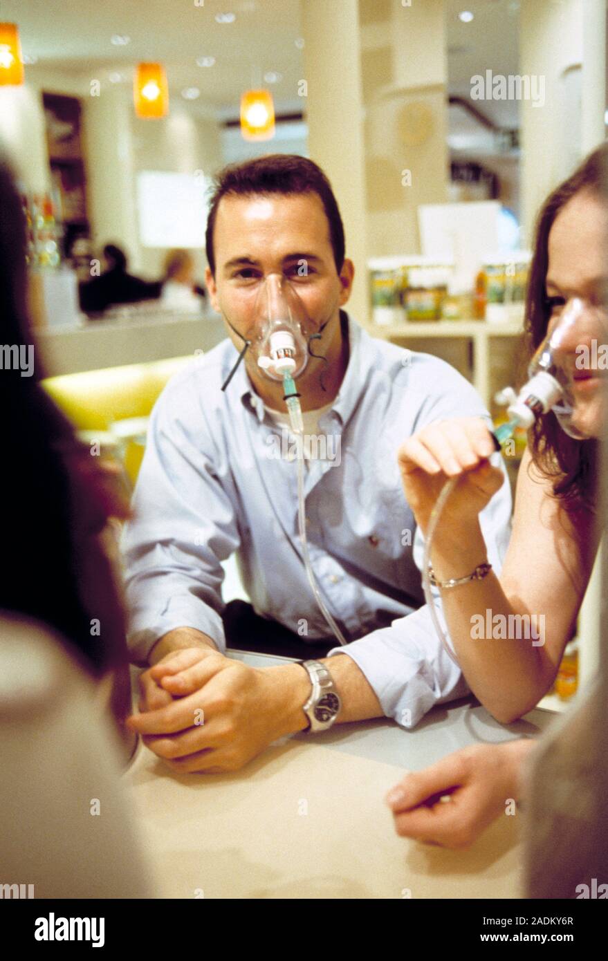 Oxygen bar. Group of friends inhaling oxygen at an oxygen bar ...