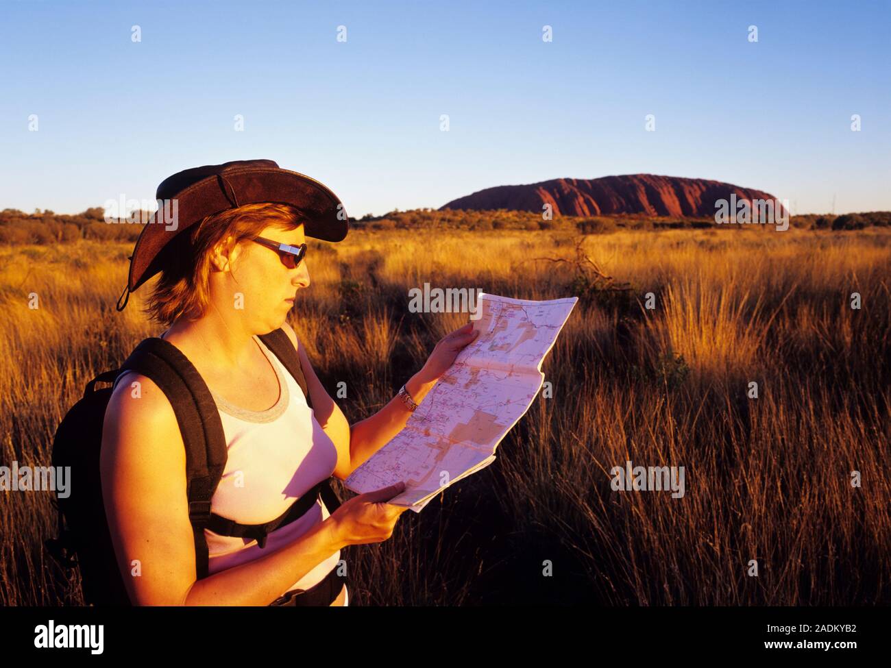 Tourist at Uluru (Ayers Rock), Australia. Female tourist using a map in ...