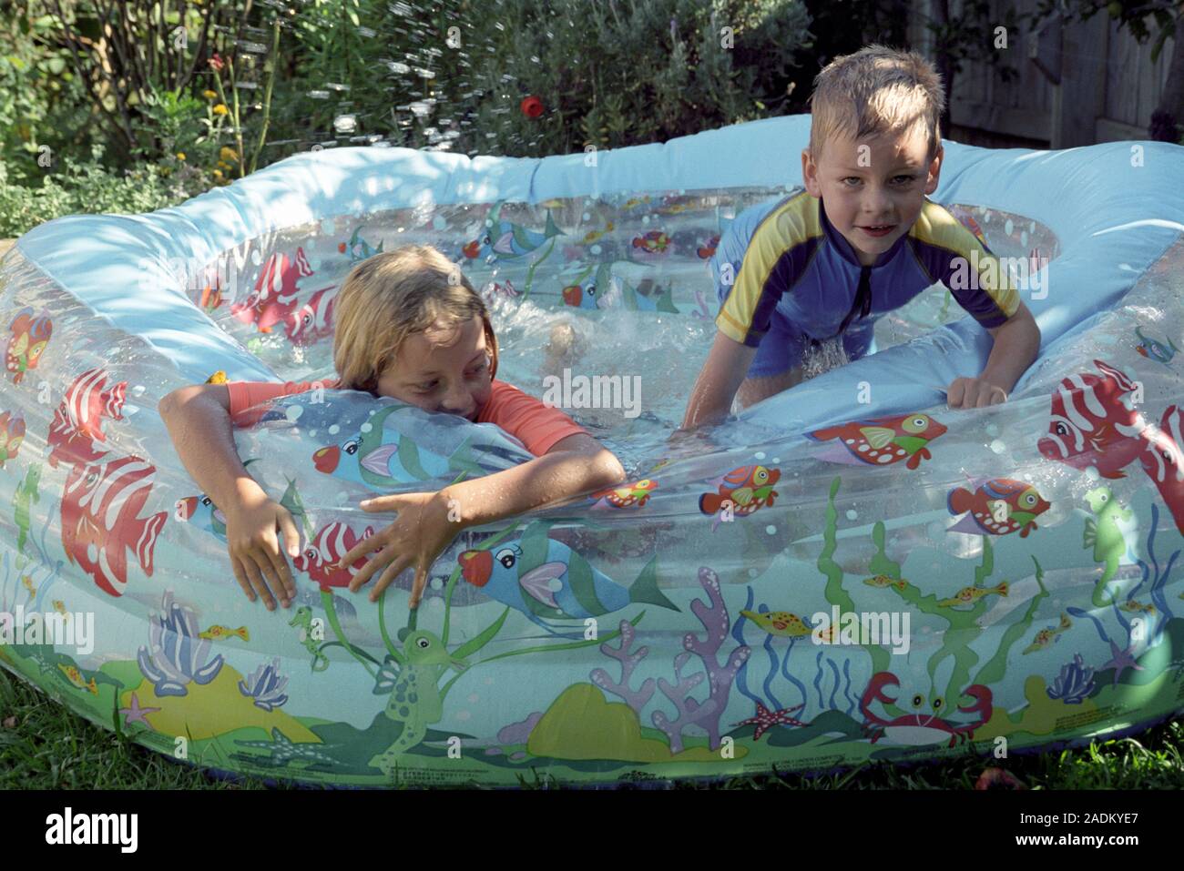 MODEL RELEASED. Children playing in a paddling pool Stock Photo - Alamy