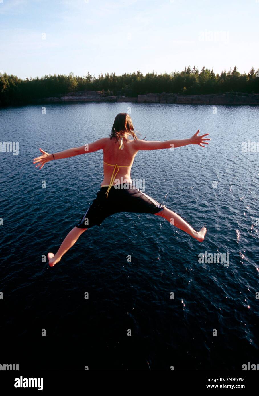 Girl jumping into a lake. Photographed in Sweden Stock Photo - Alamy