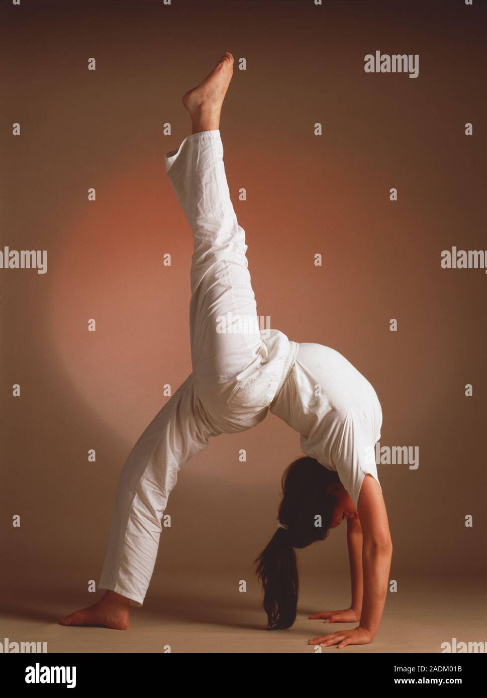 Exercise. Woman stretching her leg from a 'crab' position during ...